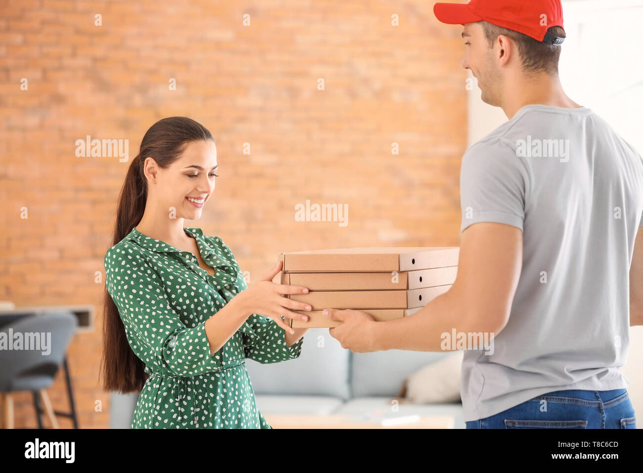 Female customer receiving pizza hi-res stock photography and images - Alamy