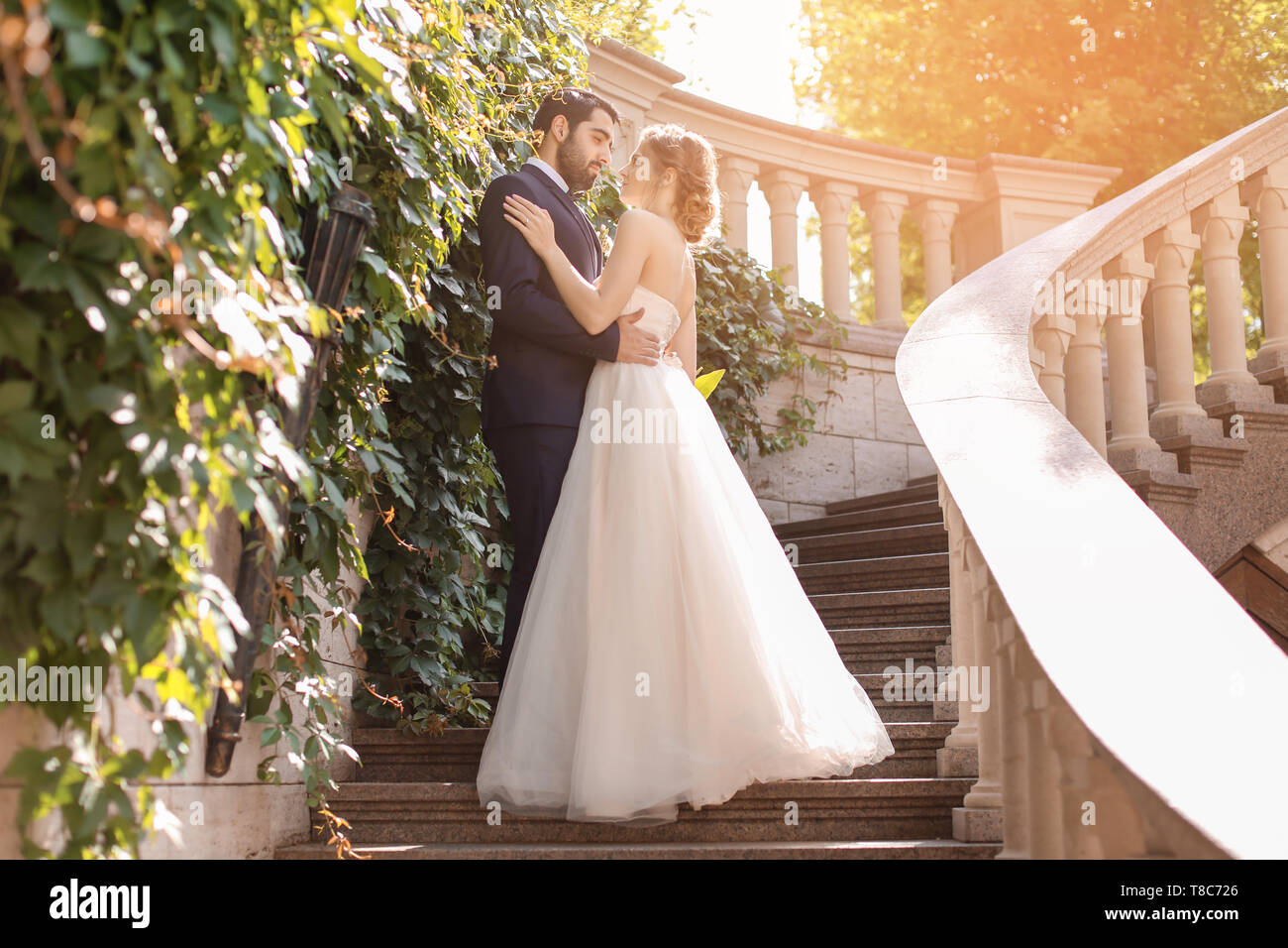 Happy wedding couple on stairs outdoors Stock Photo - Alamy