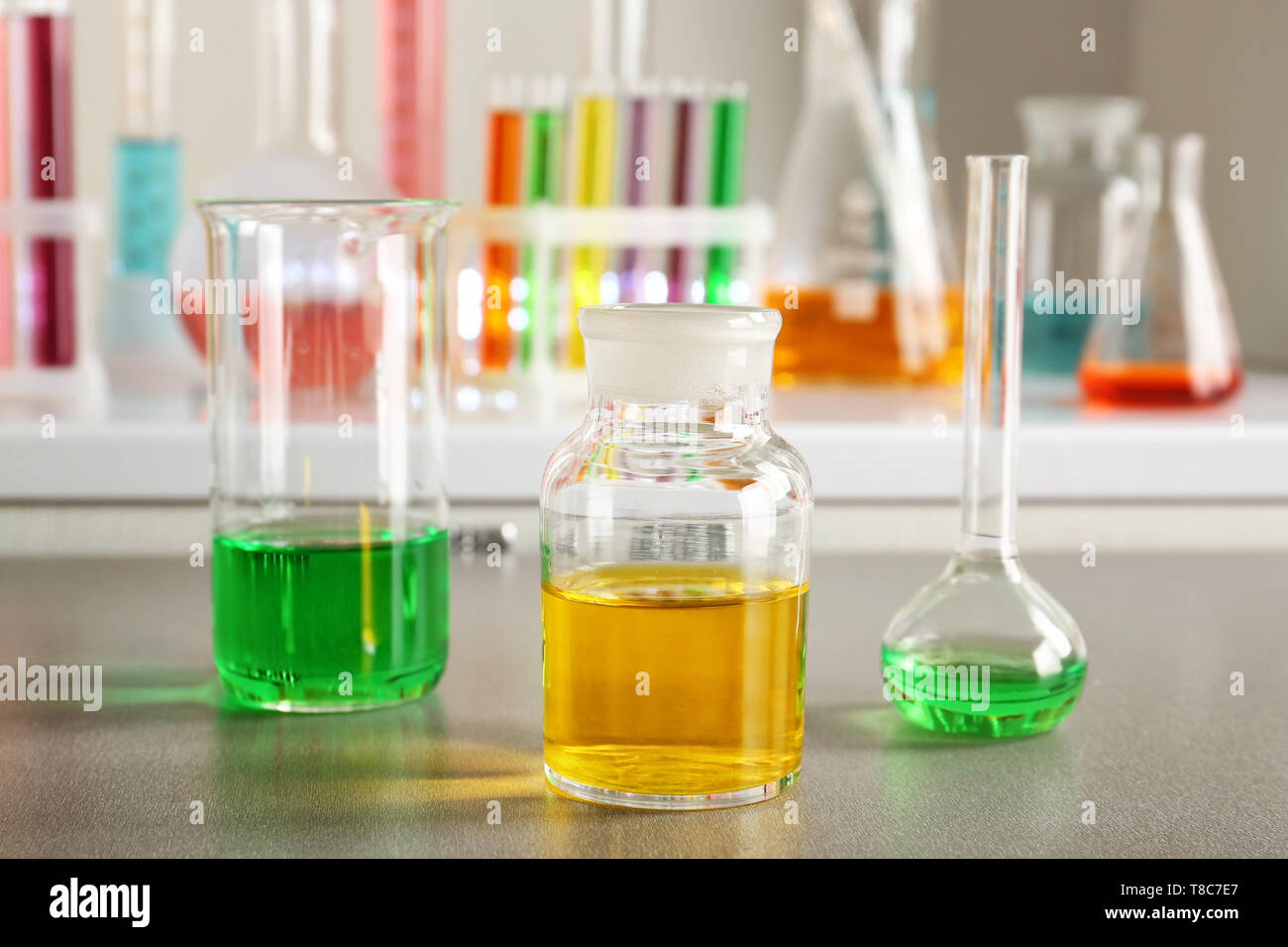 Chemical glassware with colorful samples on table in laboratory Stock ...
