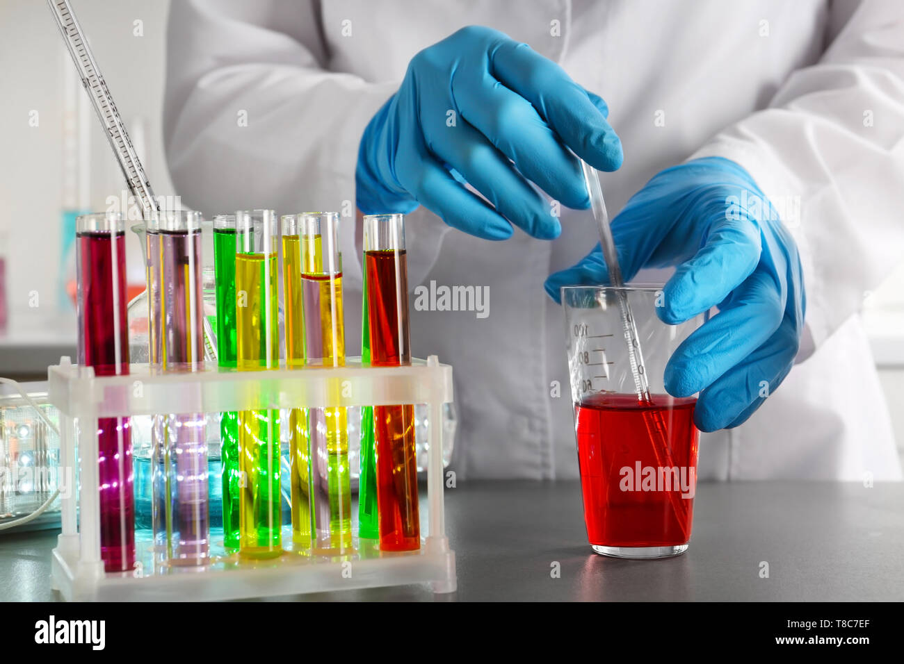 Laboratory worker taking sample from beaker, closeup Stock Photo - Alamy