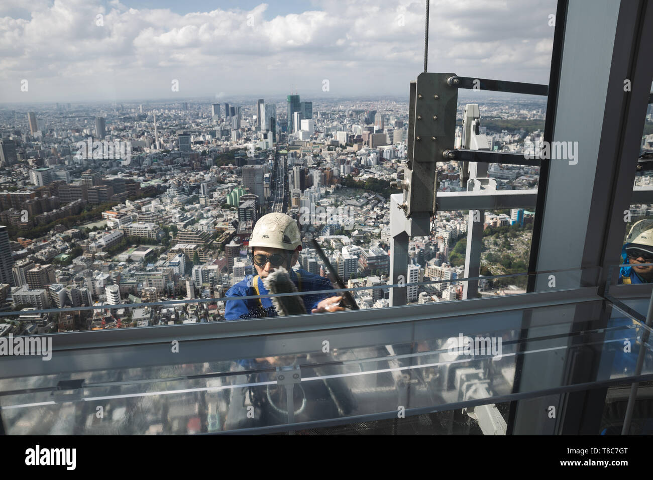 tokyo,japan - oct,9,2018:worker cleaning the window of the high ...