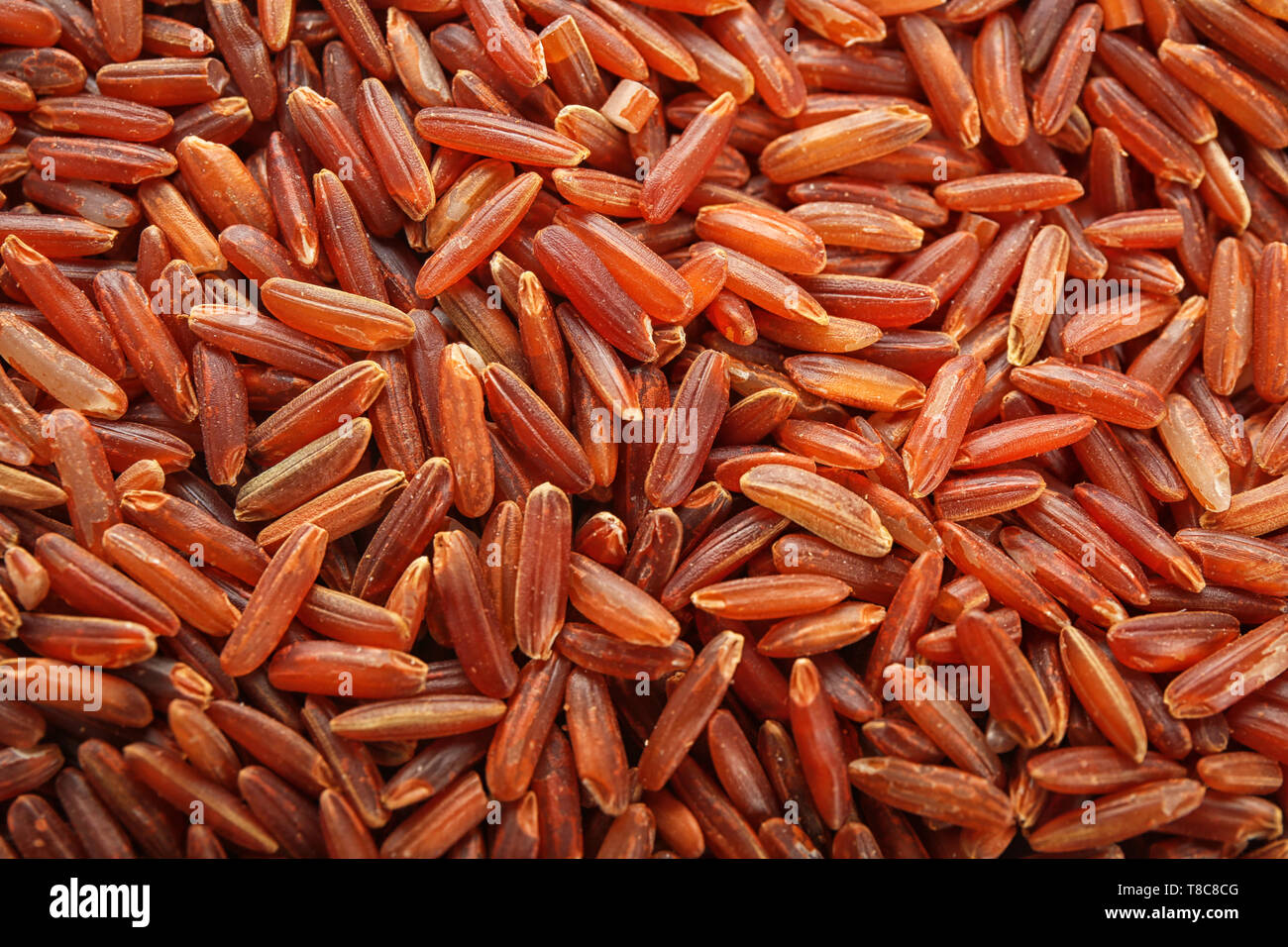 Raw red rice as background Stock Photo - Alamy