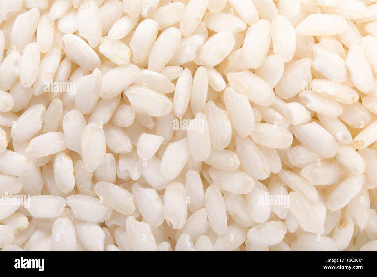 Raw white rice as background Stock Photo - Alamy