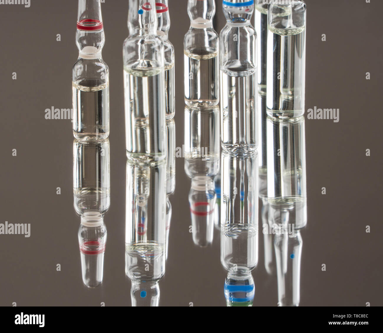 medical ampoules for injections on a dark background with reflection ...