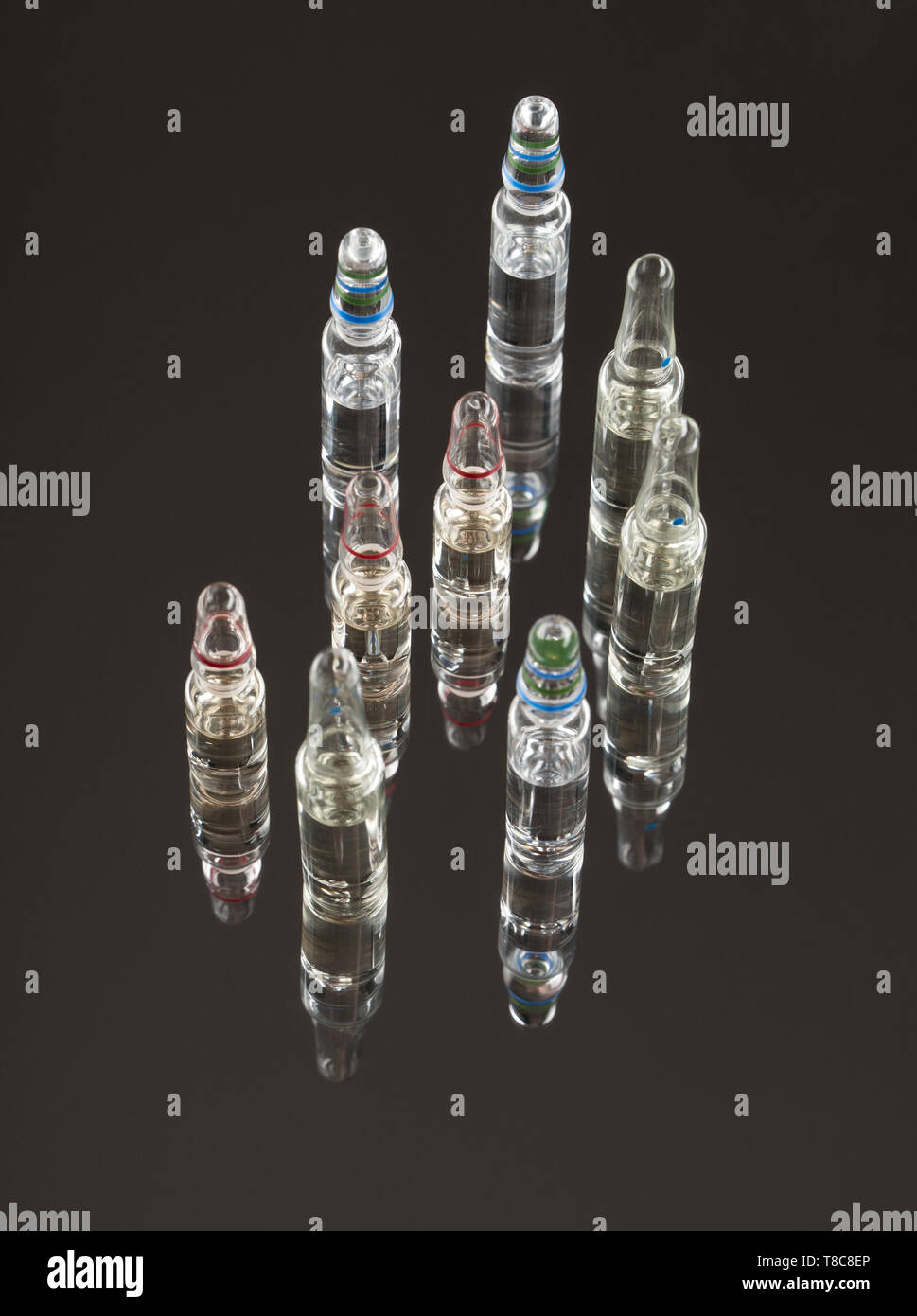 medical ampoules for injections on a dark background with reflection ...