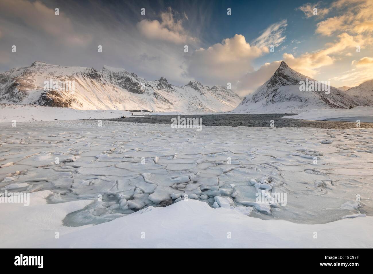 Frozen fjord at sunset, behind mountains, Volandstinden, Fredvang ...