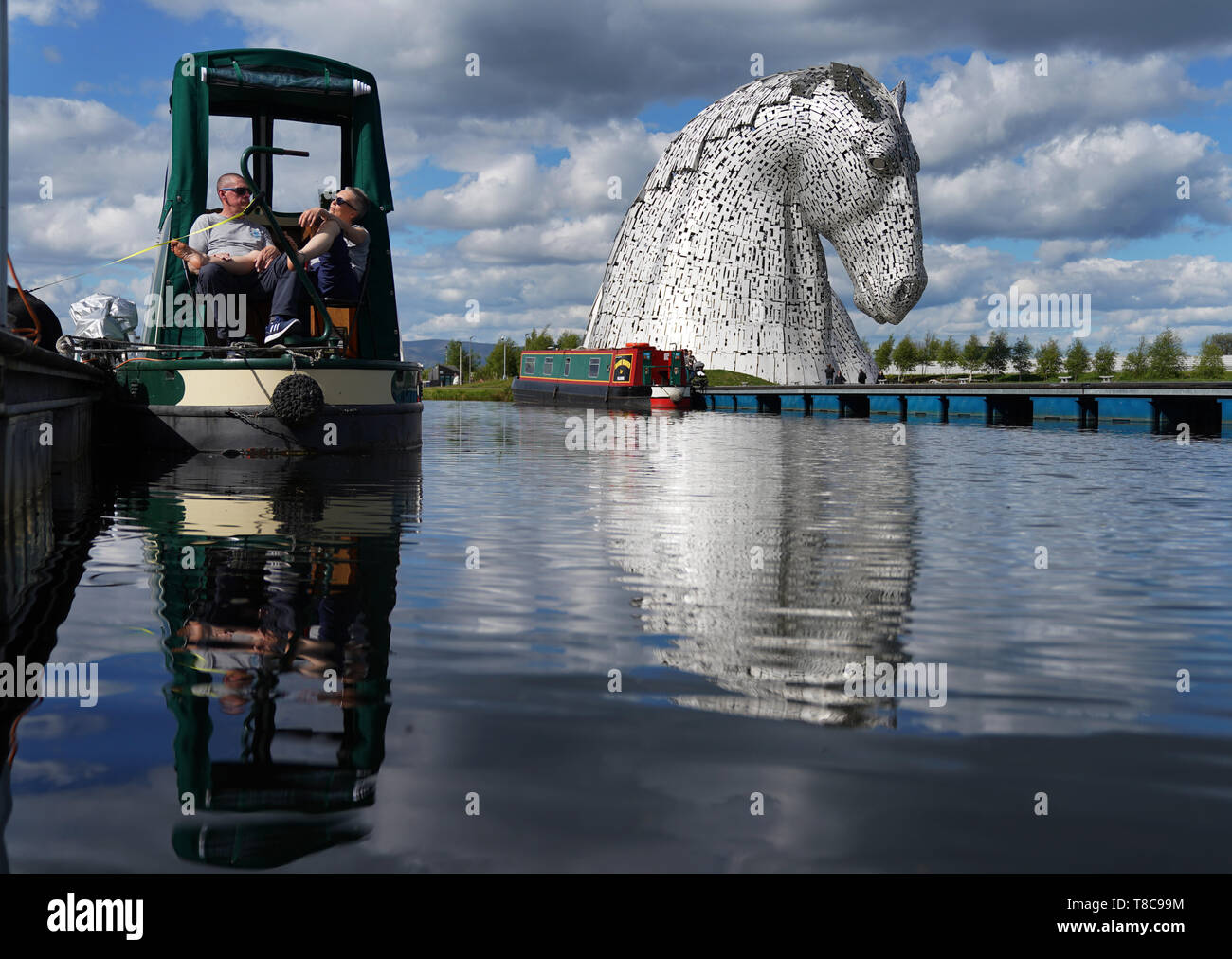 People enjoy the sun at The Kelpies in Falkirk, Scotland Stock Photo ...
