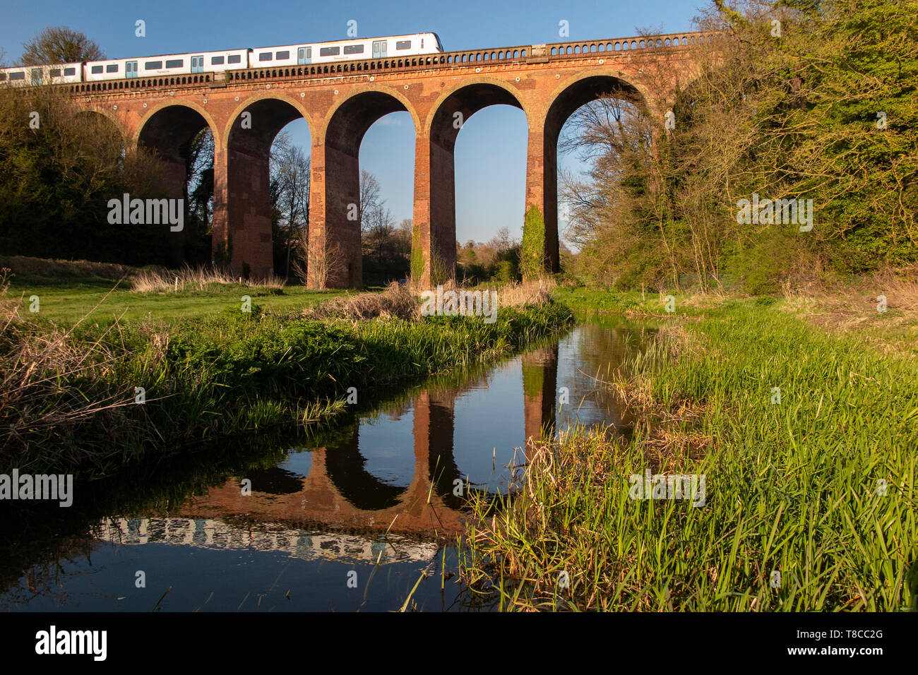 A train crosses Eynsford viaduct over the River Darent in Kent on a ...