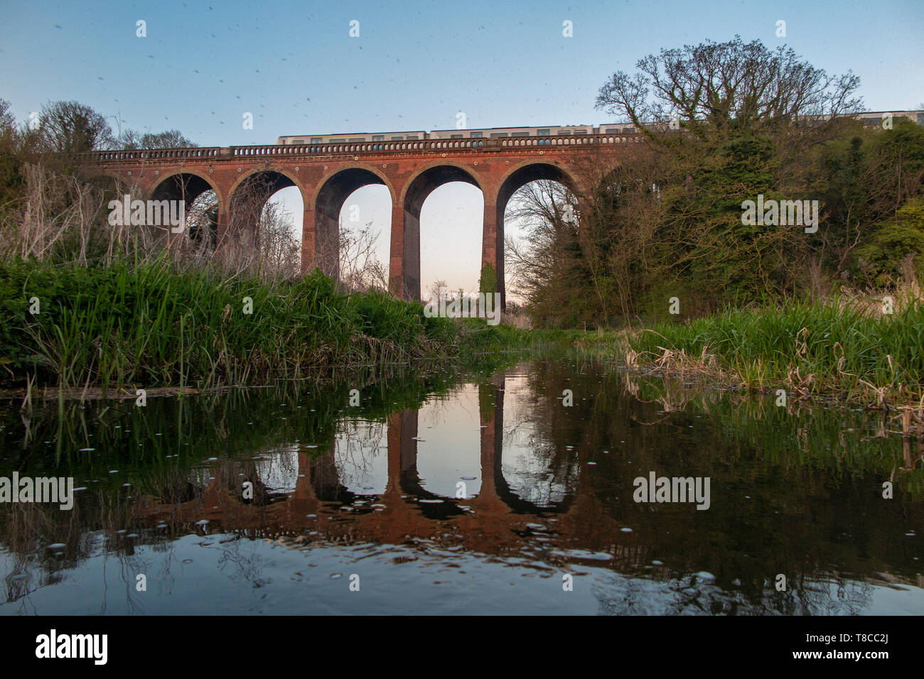A train crosses Eynsford viaduct over the River Darent in Kent on a ...