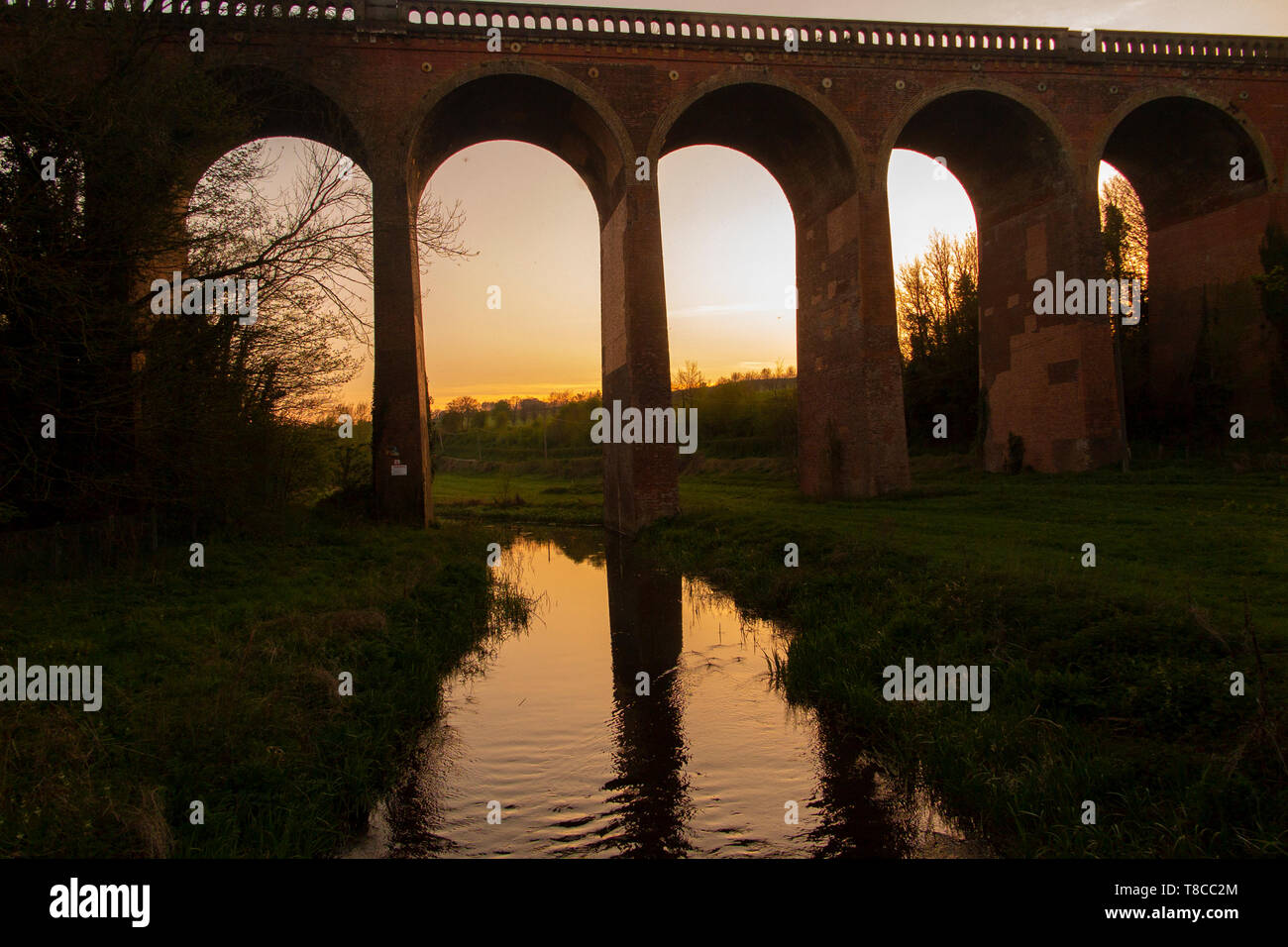 A goods train crosses Eynsford viaduct over the River Darent in Kent at ...