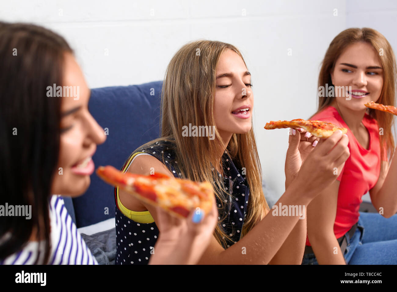 Young people having fun at party with delicious pizza indoors Stock ...