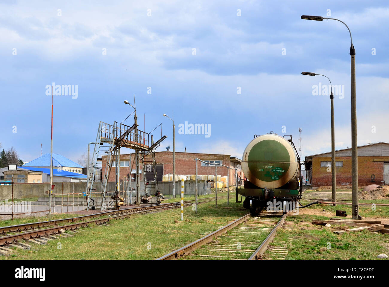 Tank car LNG by rail on oil storage tanks in fuel terminal. Discharge ...