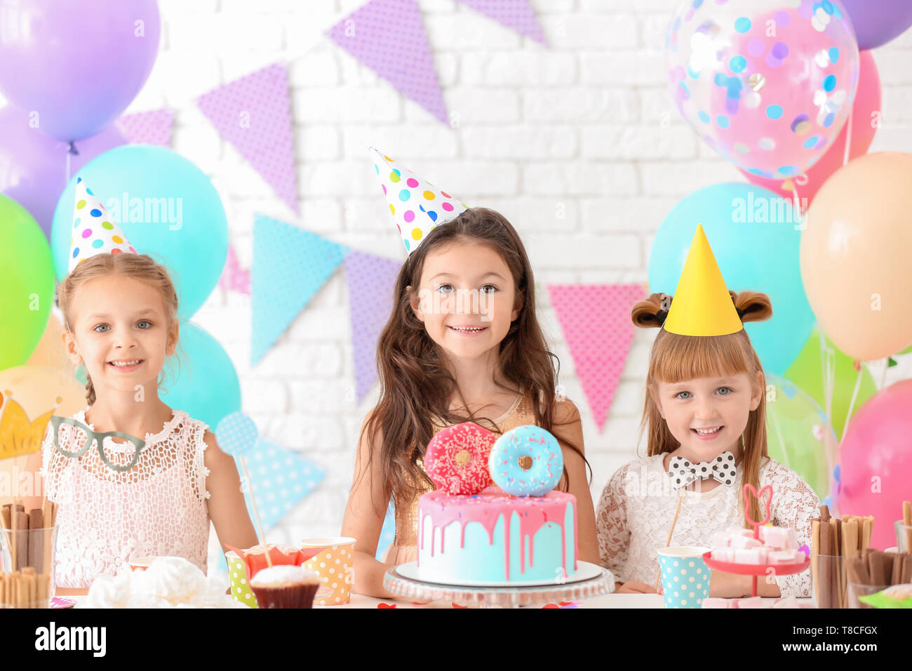 Cute little girls celebrating Birthday at home Stock Photo - Alamy