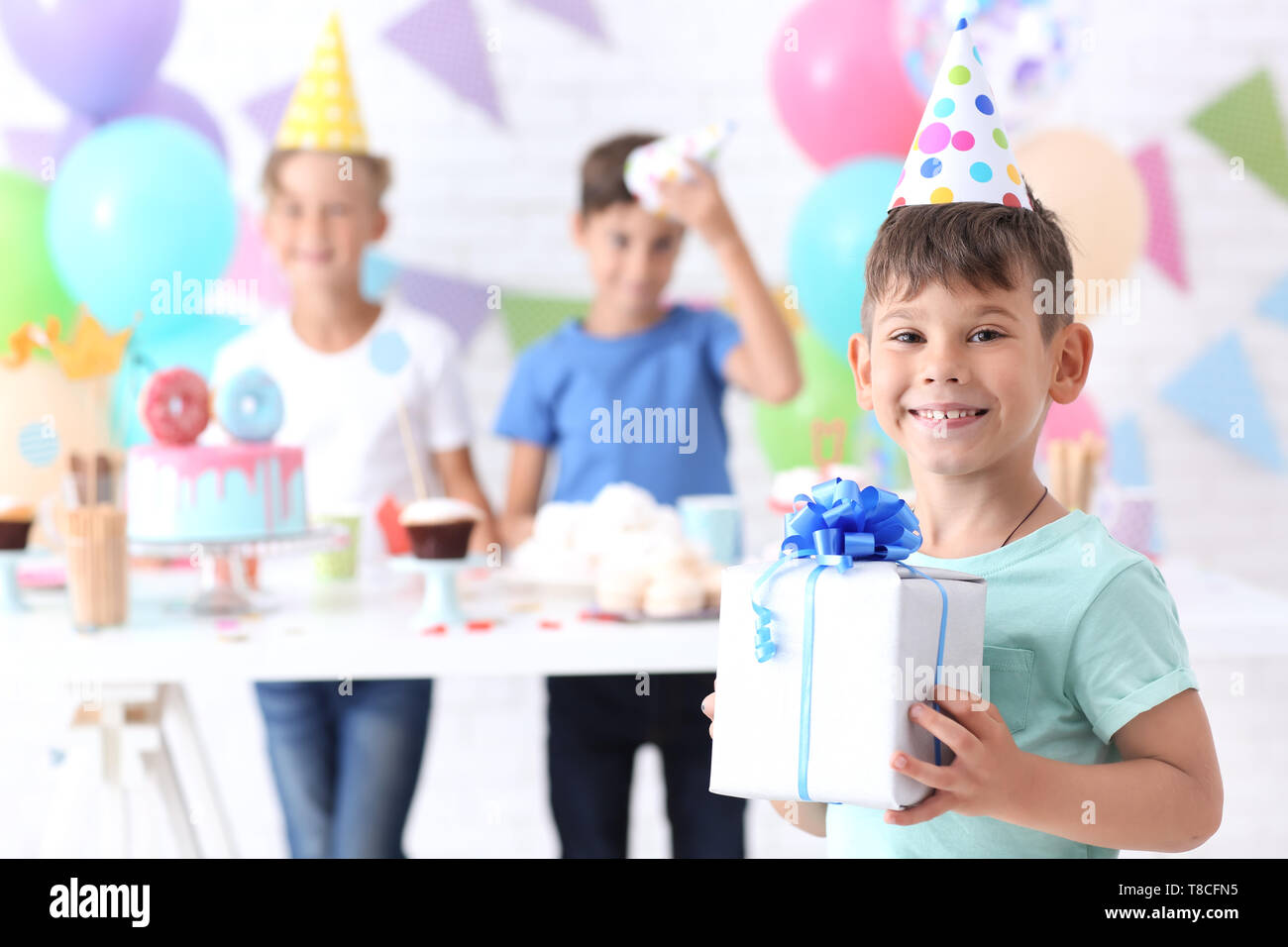 Cute little boy with Birthday gift at party Stock Photo - Alamy