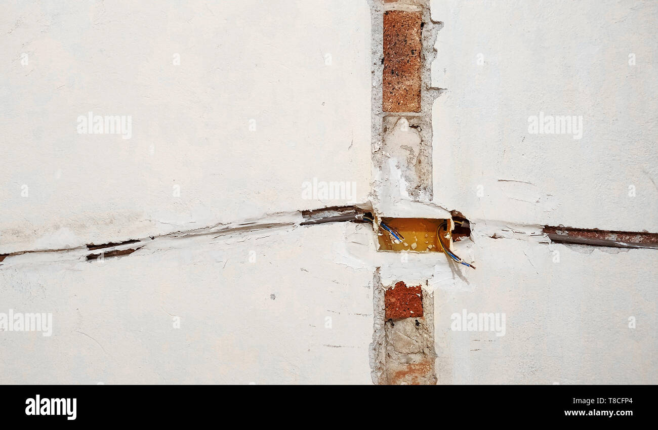 Electrical wires in the wall. Socket holes and electrical cables on the ...