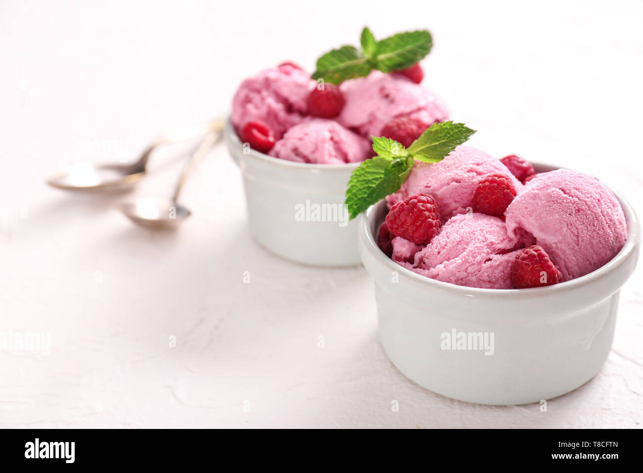 Bowls with tasty raspberry ice-cream on white background Stock Photo ...
