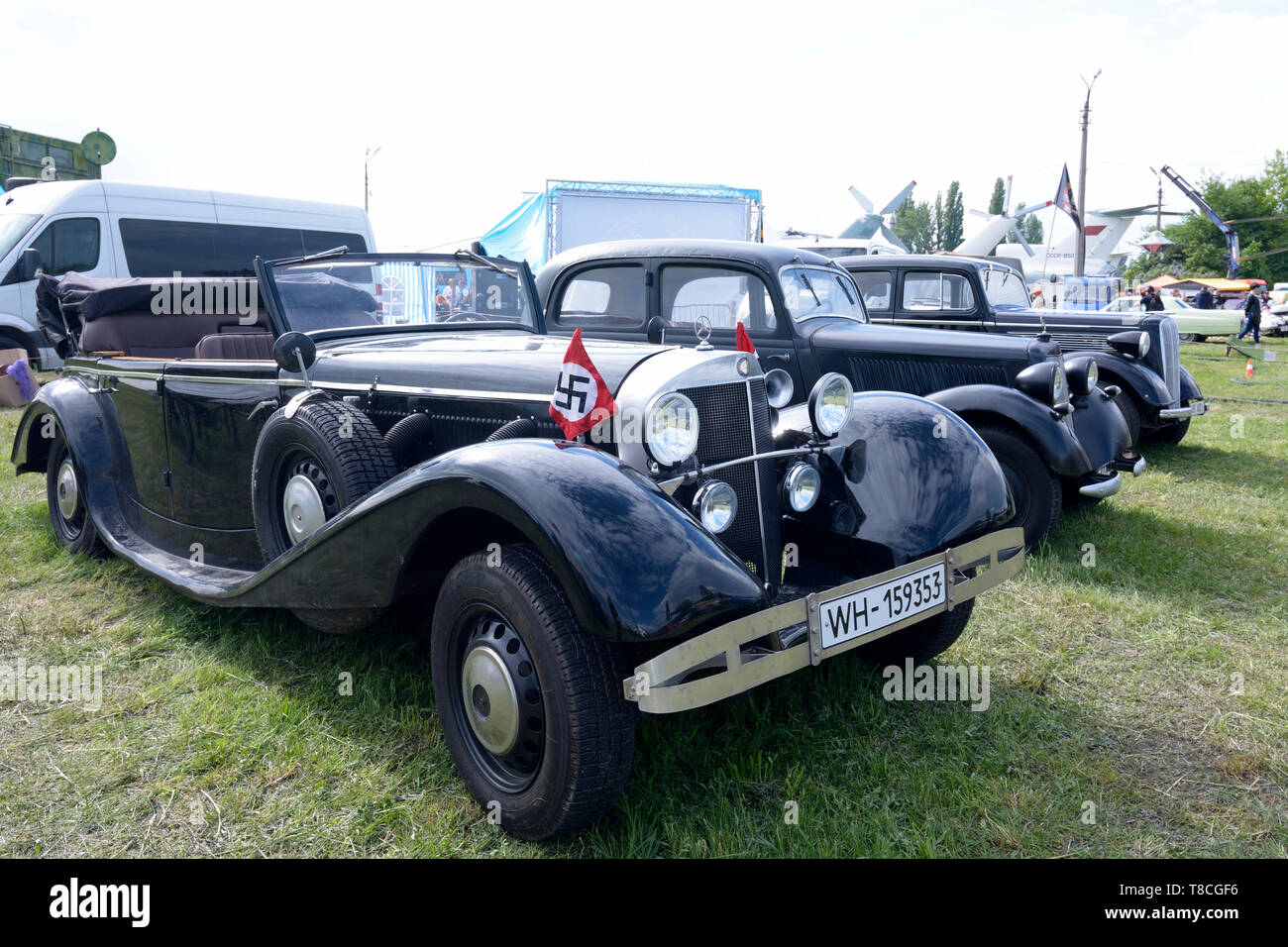 Germany retro cars Mercedes parked, flags with swastica on a hood ...