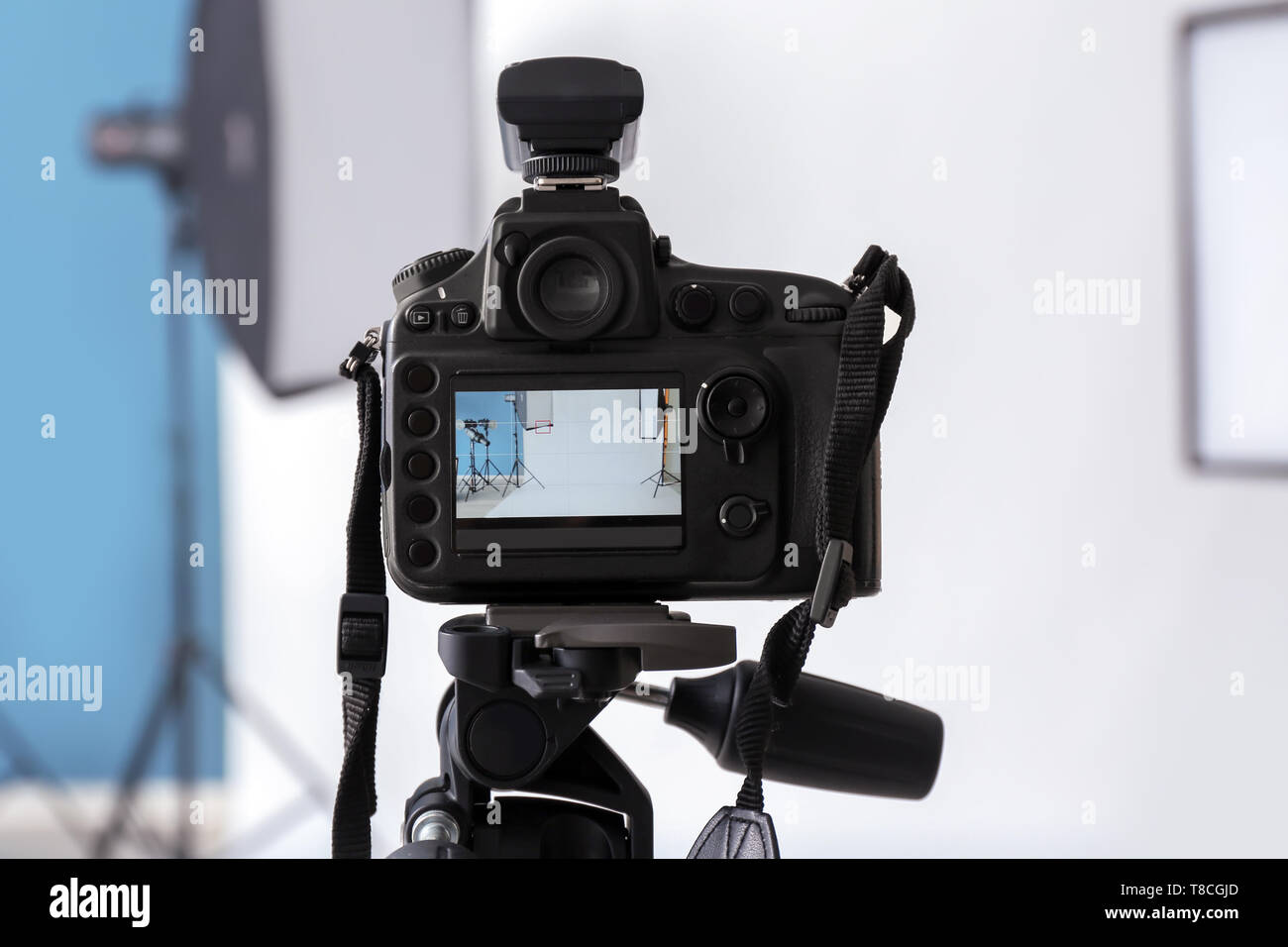 Professional camera on tripod in photo studio Stock Photo - Alamy