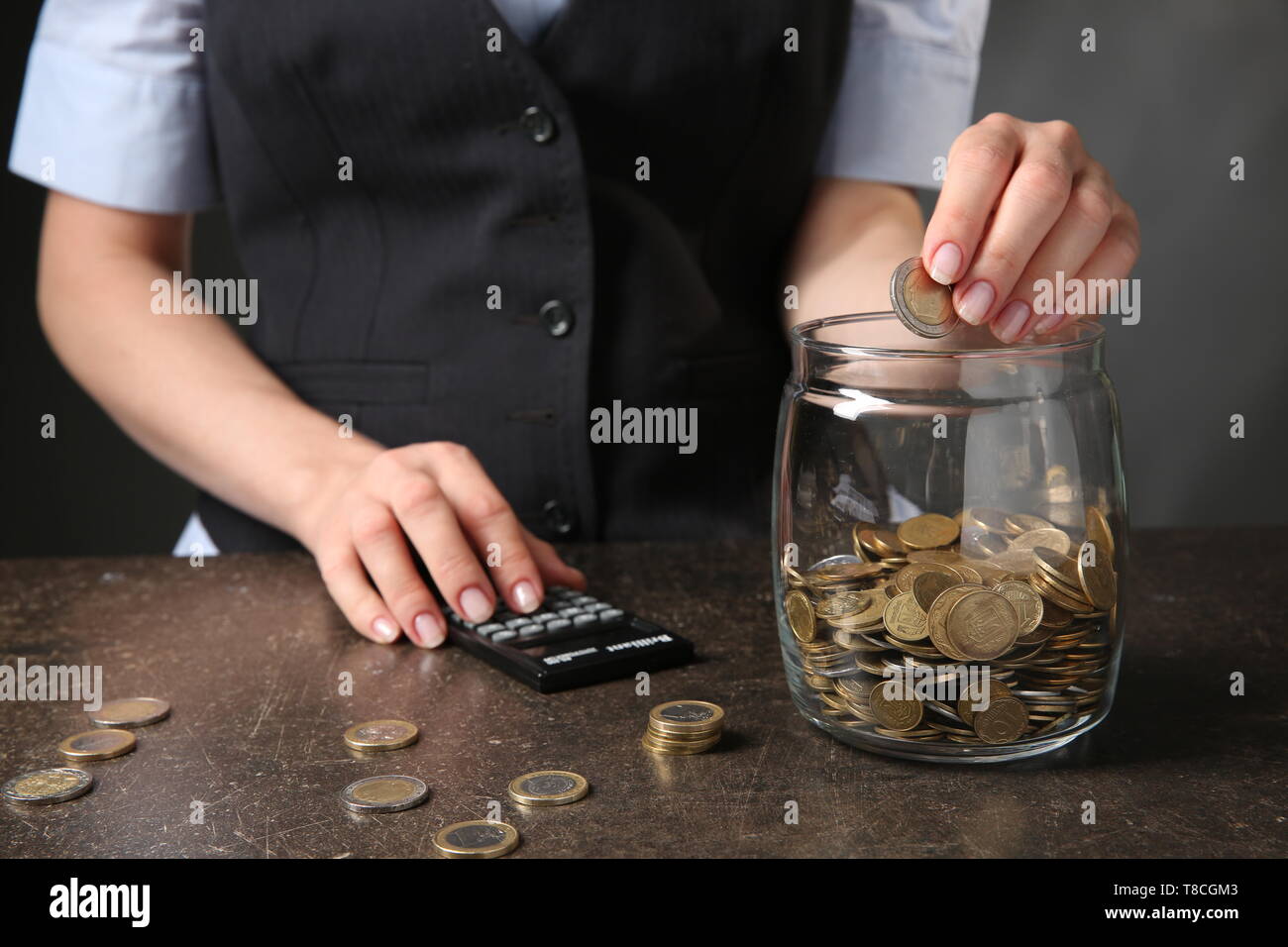 Woman counting coins at table. Savings concept Stock Photo - Alamy