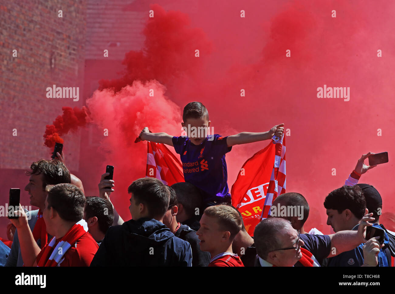 Fans let off flares before the Premier League match at Anfield ...