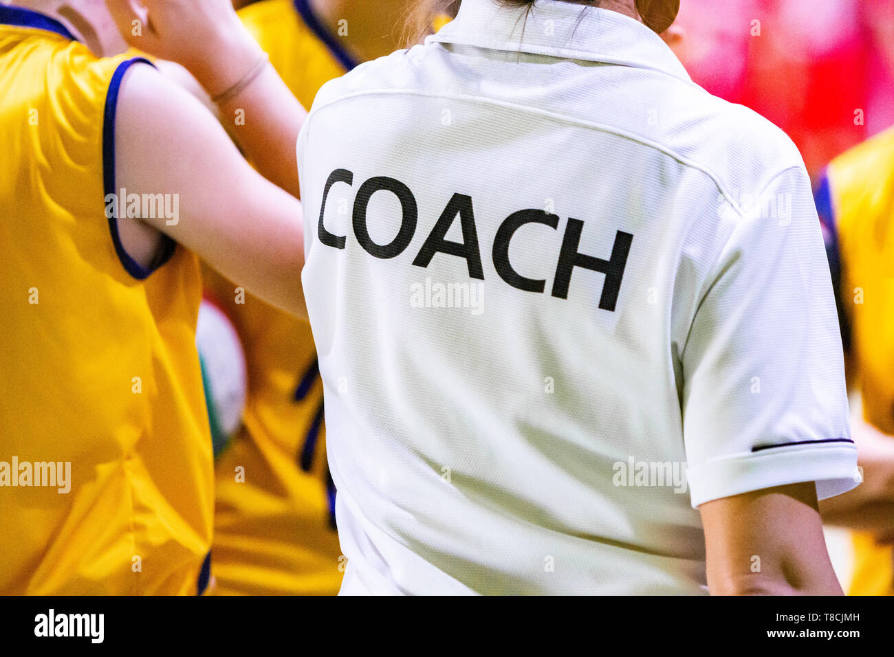 Female coaches in white COACH shirt at an indoor sport game Stock Photo ...