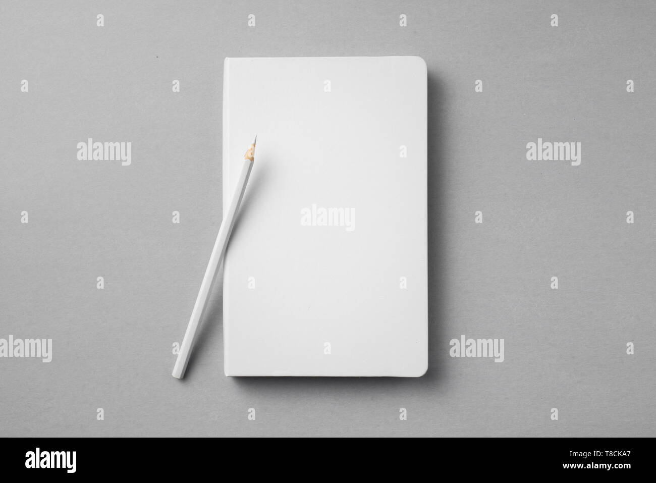 Design concept - top view of close white notebook with wooden pencil on ...