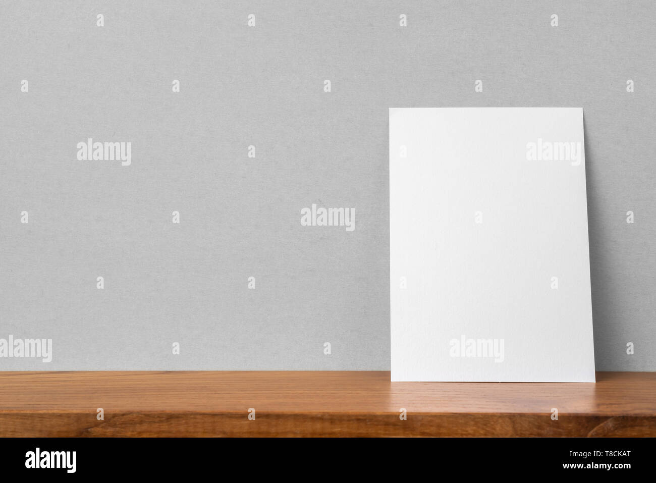 Design concept - front view of A4 paper on bookshelf and grey wall for ...