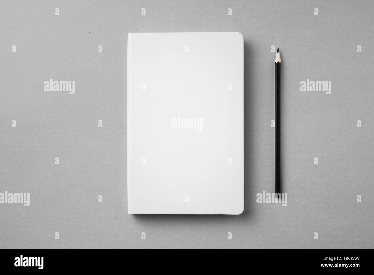 Design concept - top view of close white notebook with wooden pencil on ...