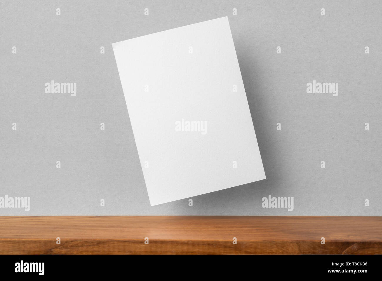 Design concept - front view of A4 paper on bookshelf and grey wall for ...