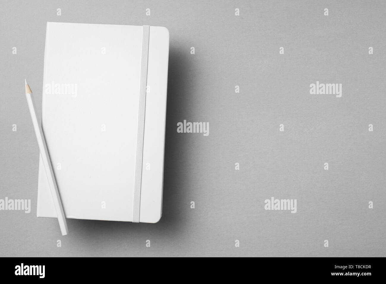 Design concept - top view of close white notebook with wooden pencil on ...