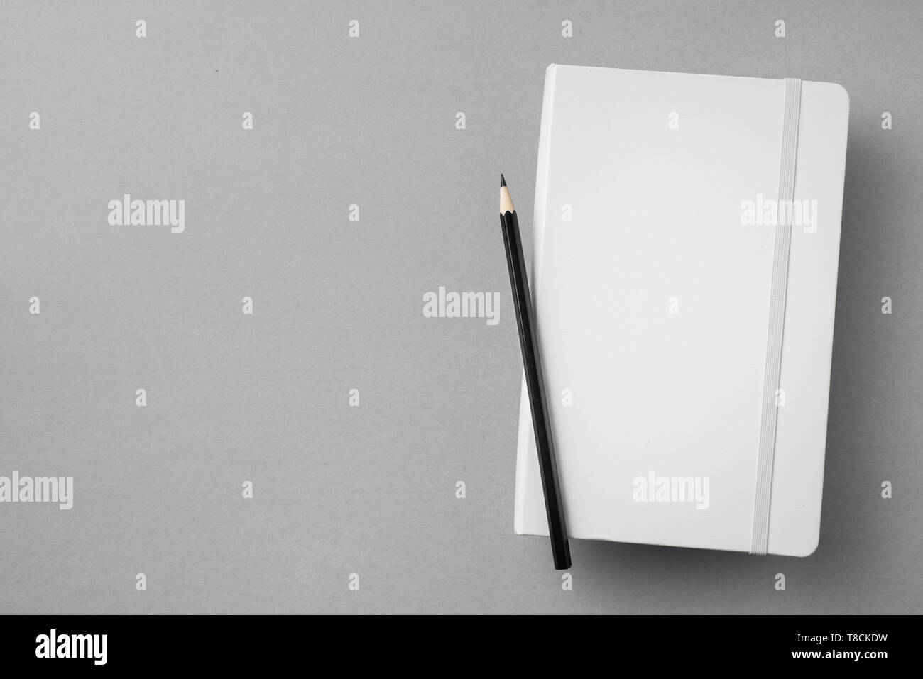Design concept - top view of close white notebook with wooden pencil on ...