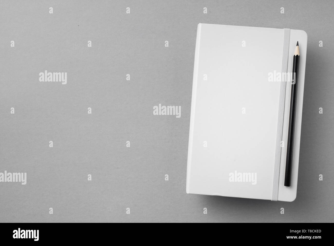 Design concept - top view of close white notebook with wooden pencil on ...