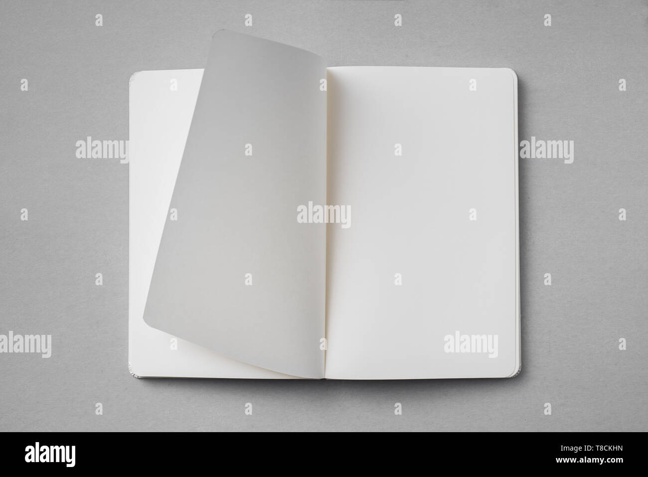 Design concept - top view of white notebook with blank open, turn and ...