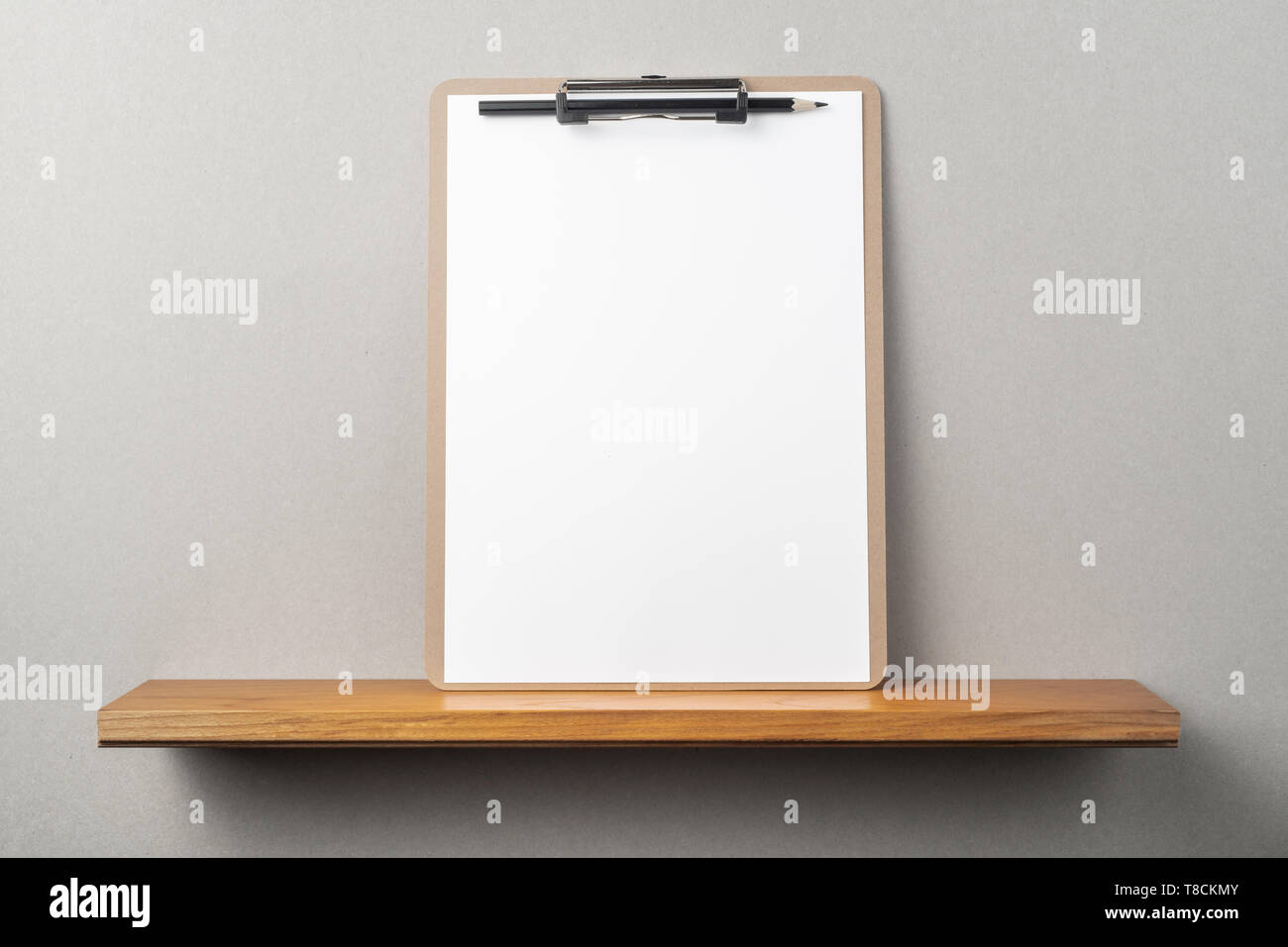 Design concept - front view of A4 paper with clipboard on bookshelf and ...