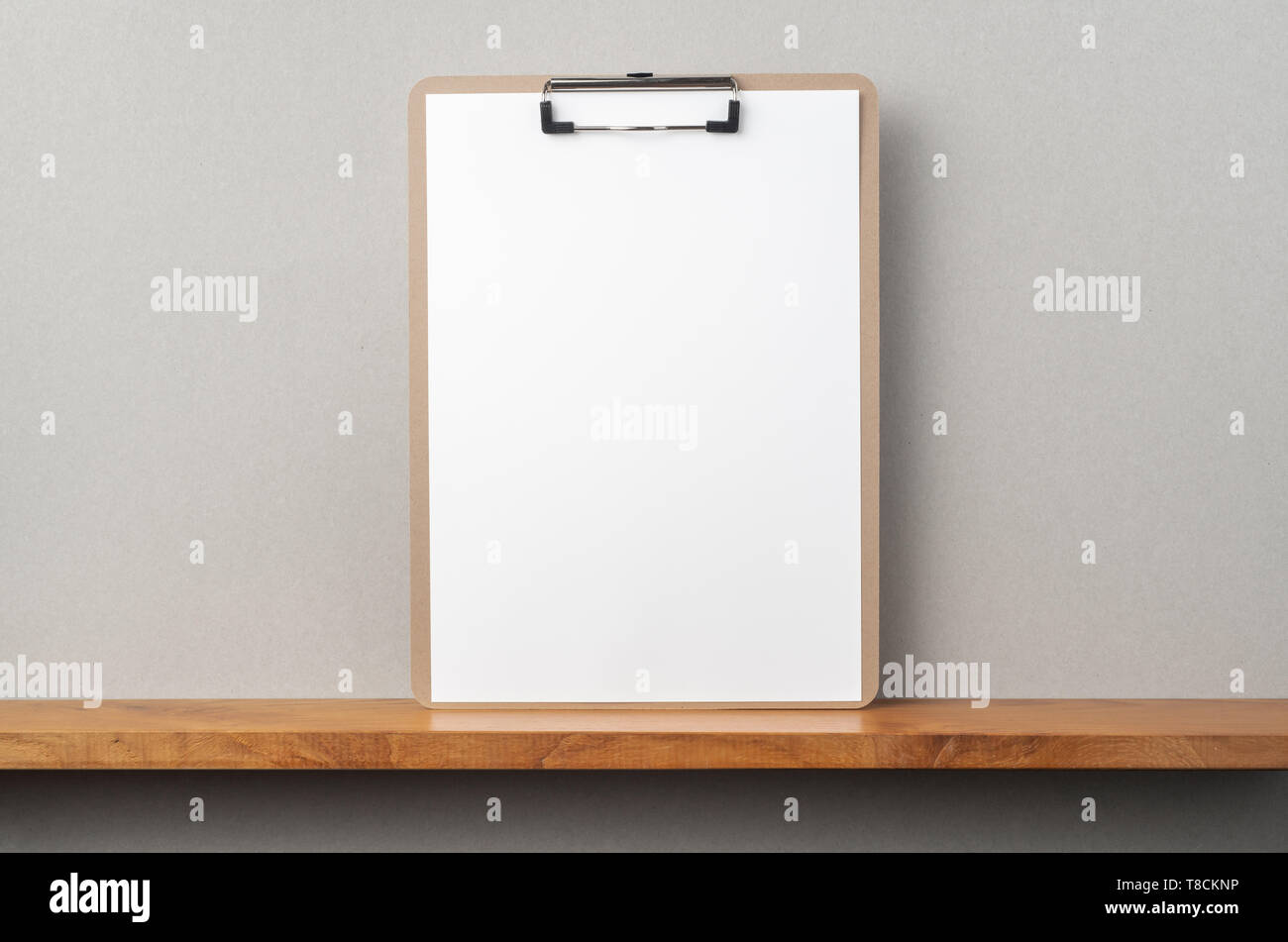 Design concept - front view of A4 paper with clipboard on bookshelf and ...