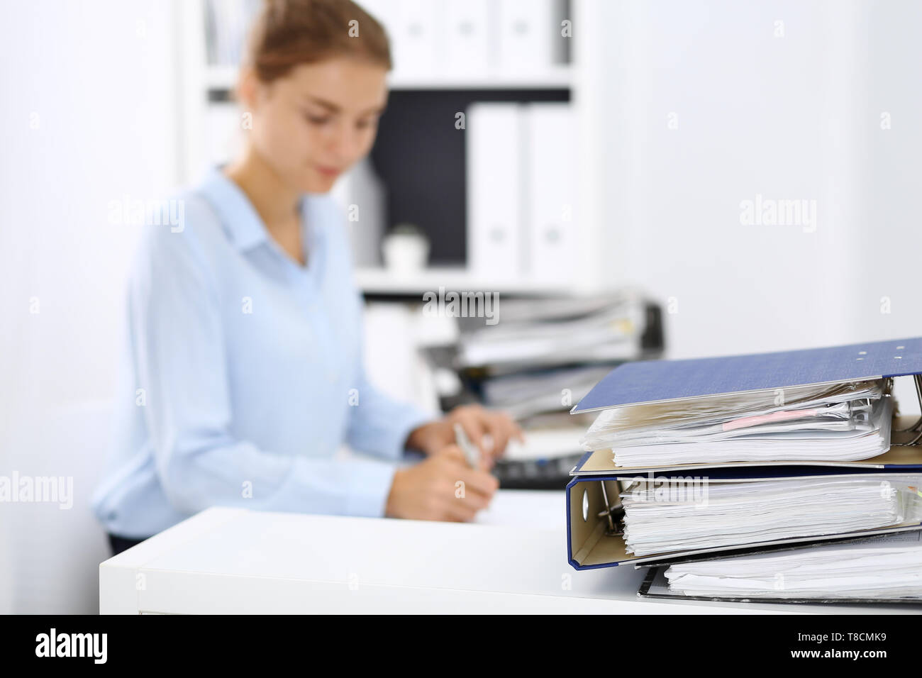 Calculator and binders with papers are waiting to be processed by ...