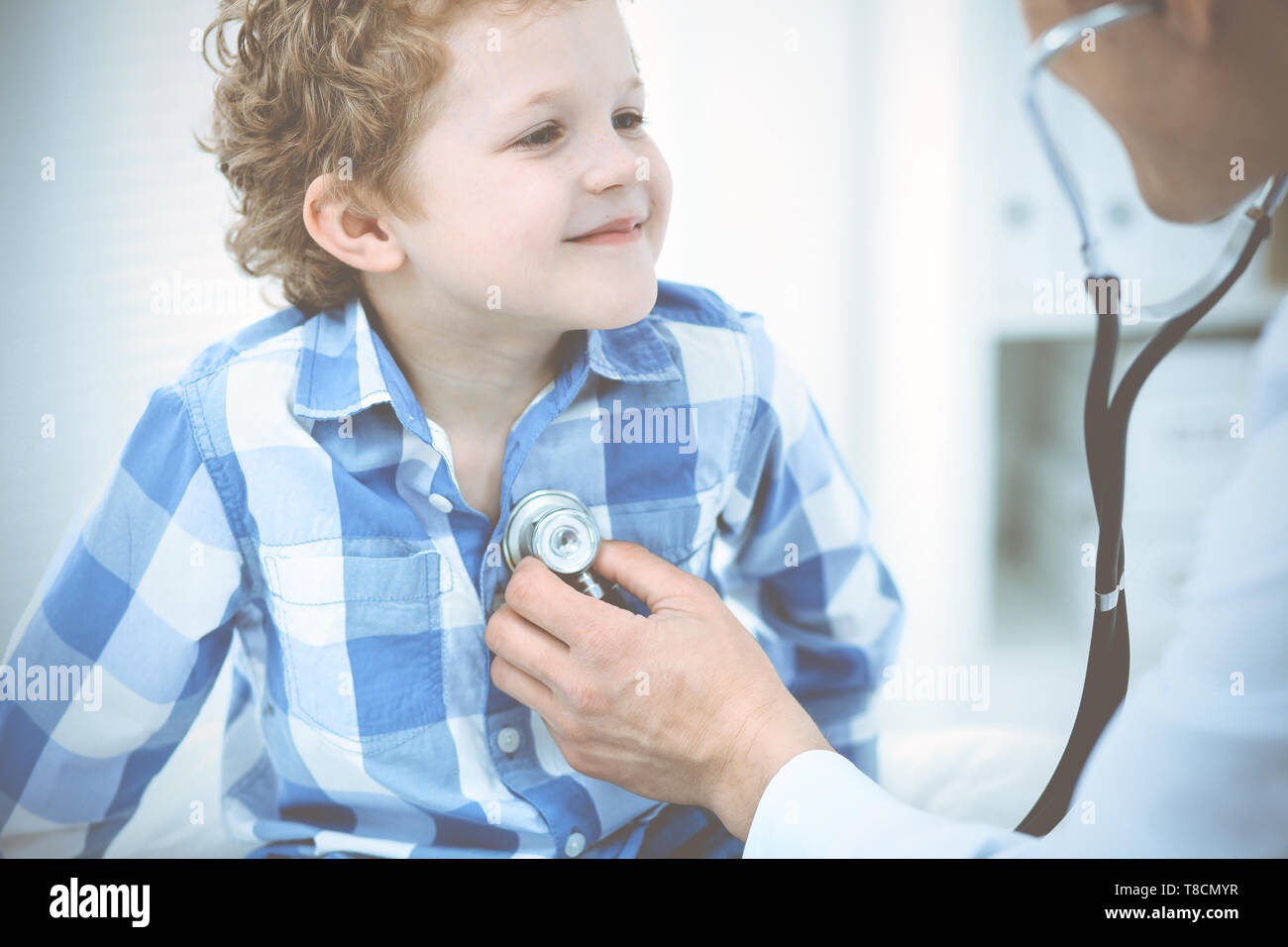 Doctor and patient child. Physician examining little boy. Regular ...