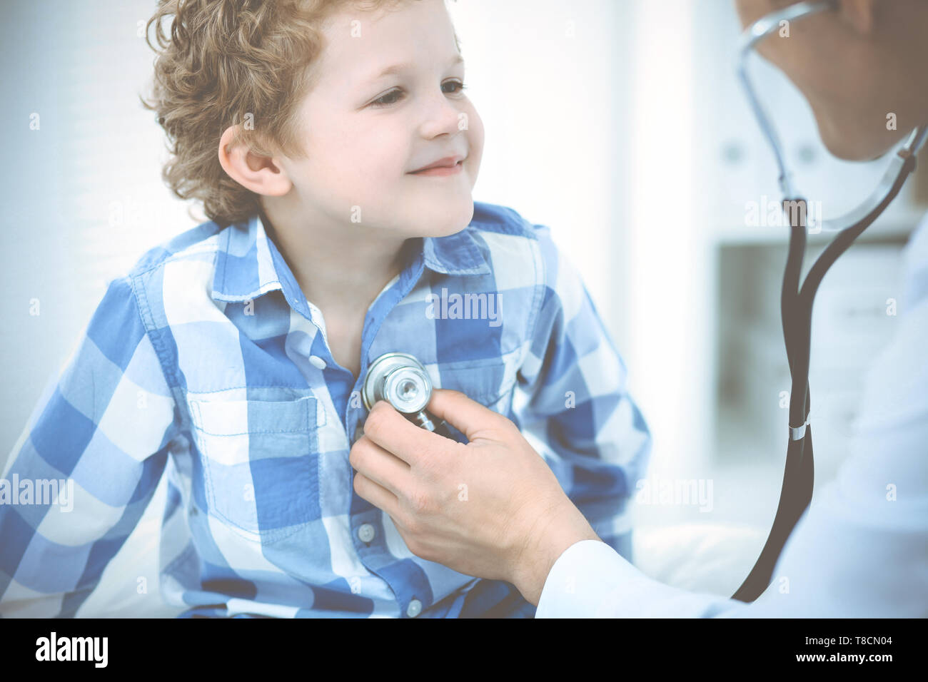 Doctor and patient child. Physician examining little boy. Regular ...