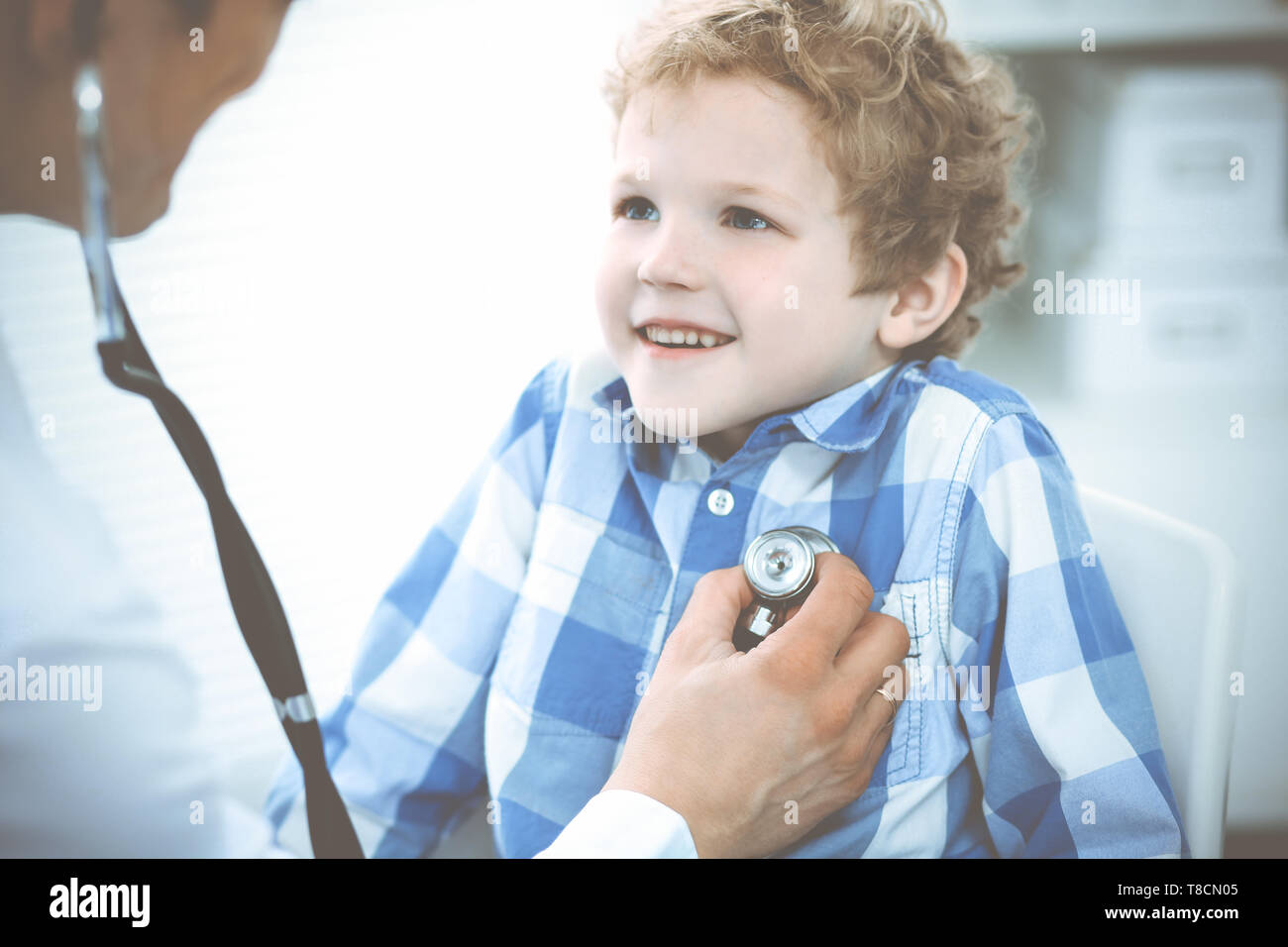 Doctor and patient child. Physician examining little boy. Regular ...