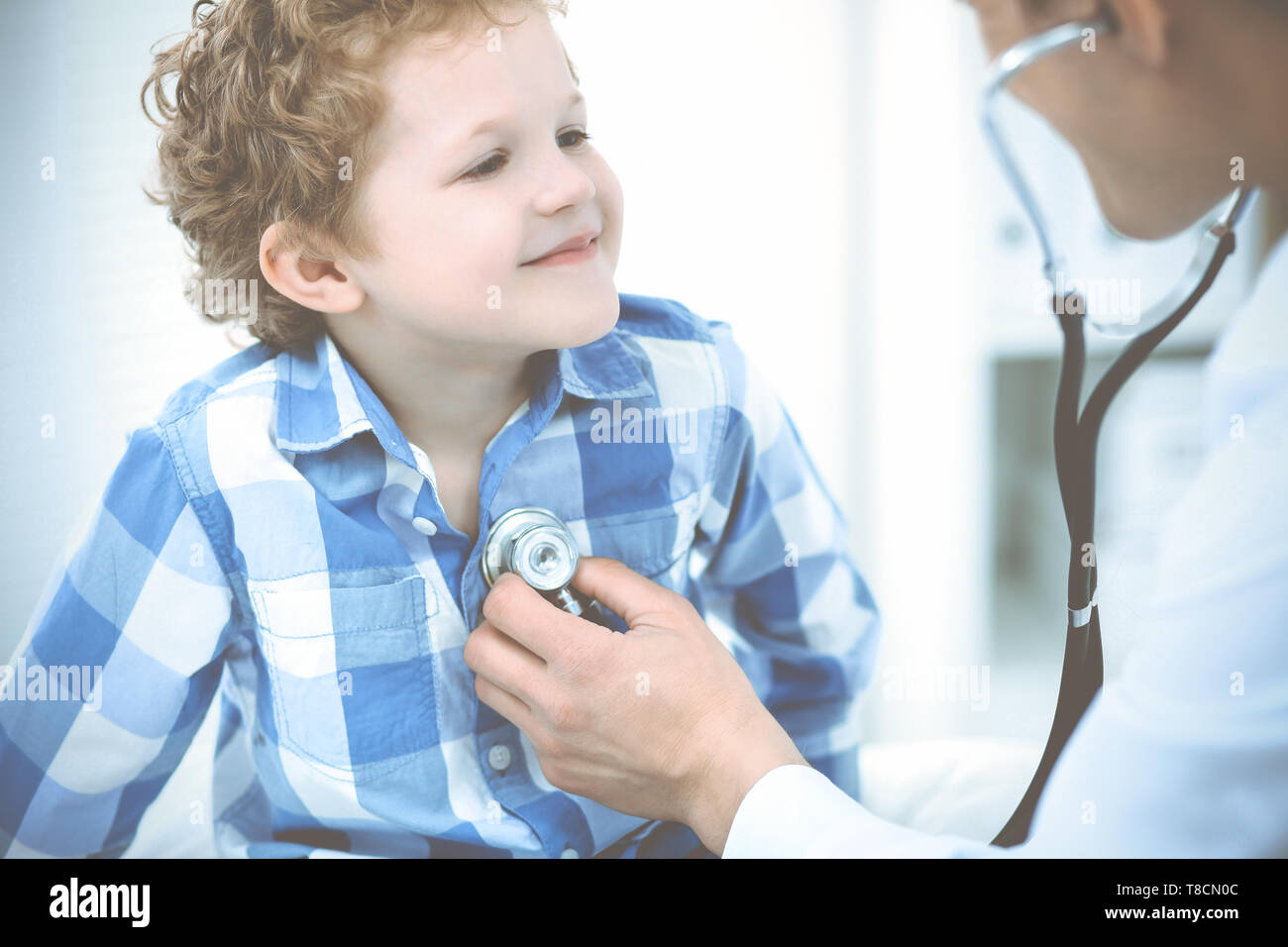 Doctor and patient child. Physician examining little boy. Regular ...