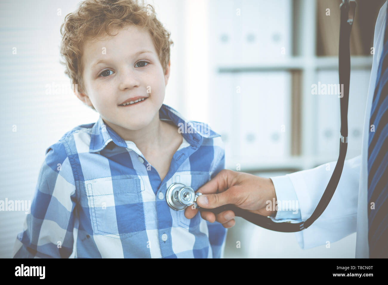 Doctor and patient child. Physician examining little boy. Regular ...