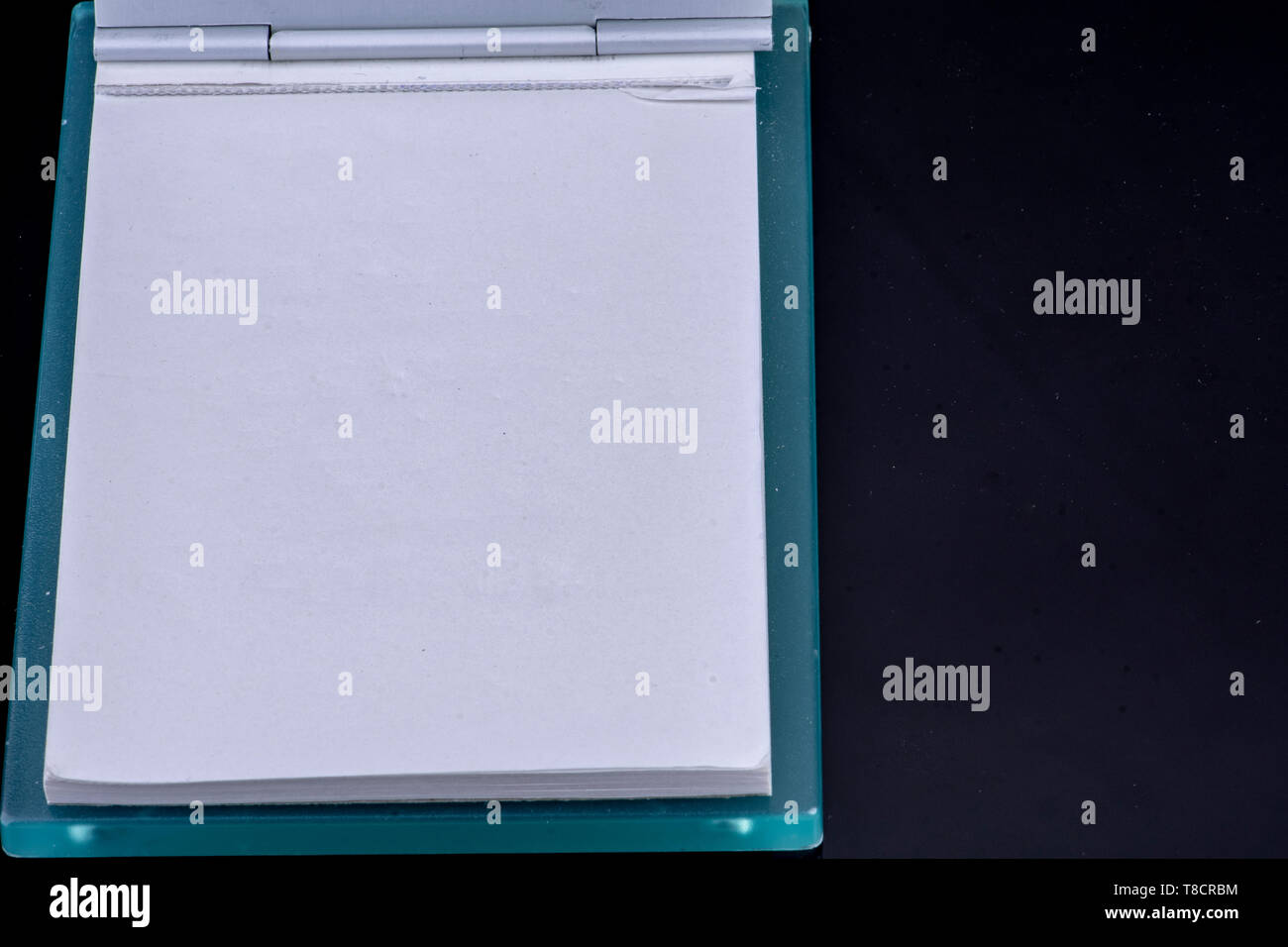 Writing pad with one blank page on black background with text free ...