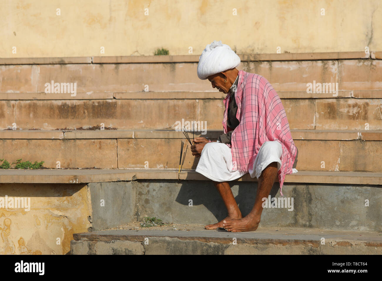 Old indian Man sitting on steps and praying Stock Photo - Alamy