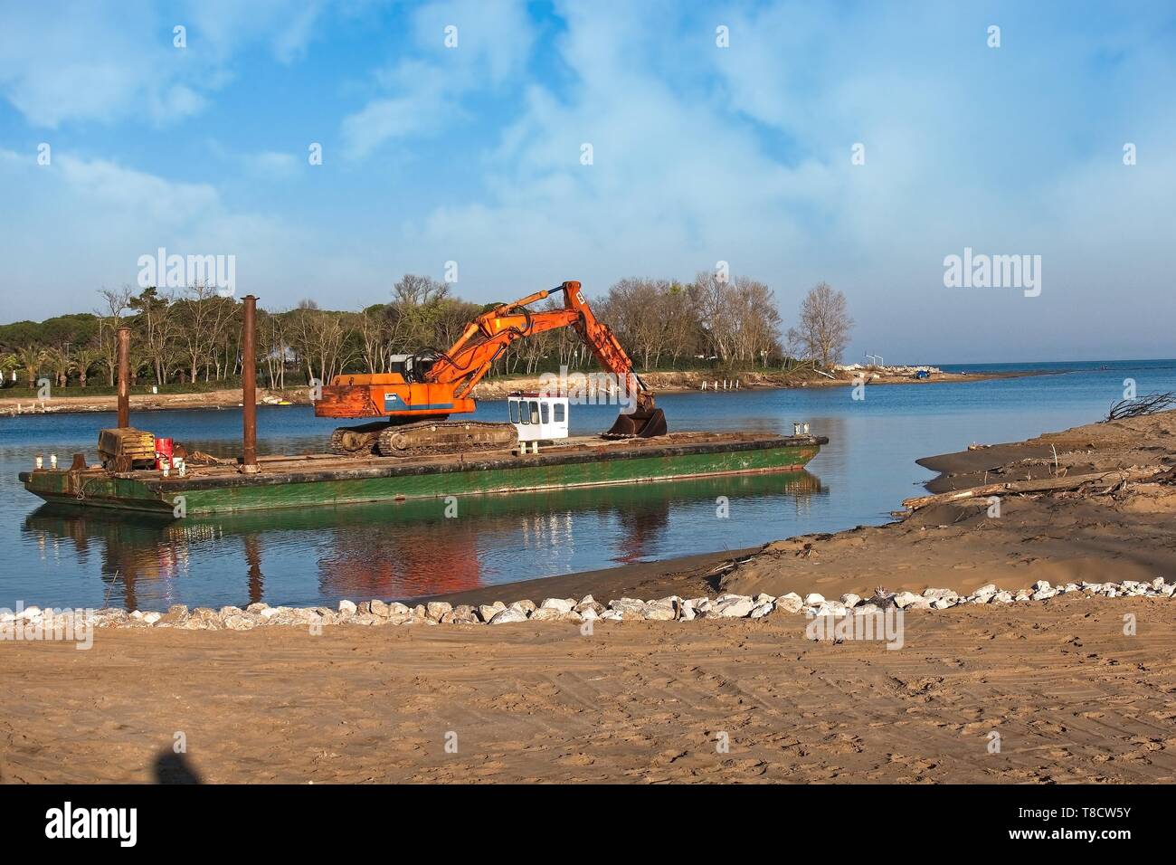 Excavator for channel dredge on a barge Stock Photo - Alamy