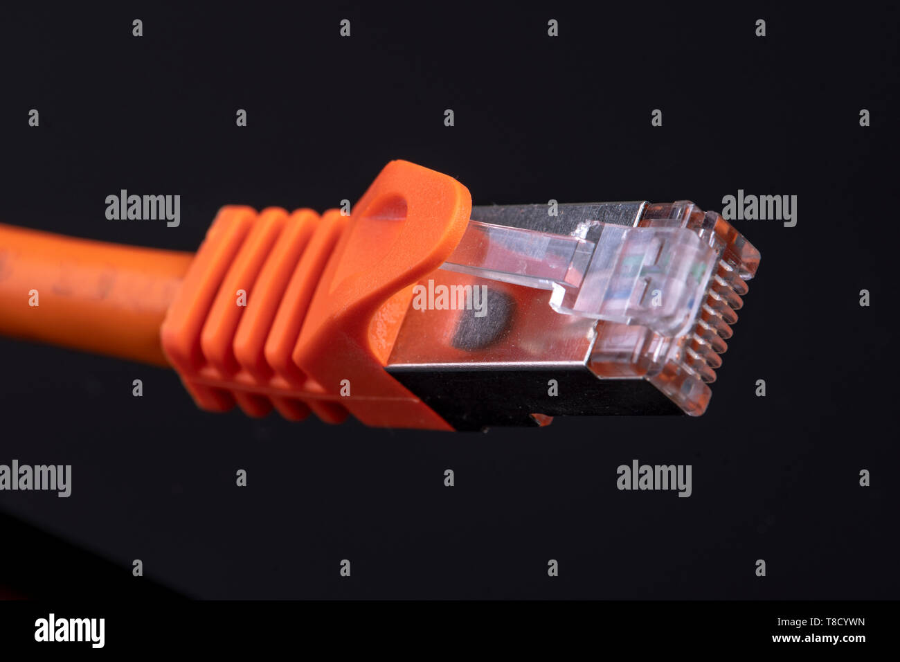 orange data cable for fast internet on black background for a modern ...