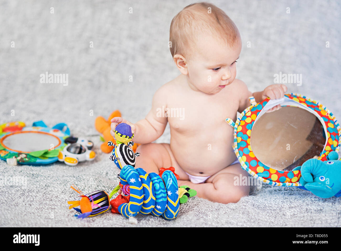 10 months baby cute kid girl playing with colorful educational toys ...