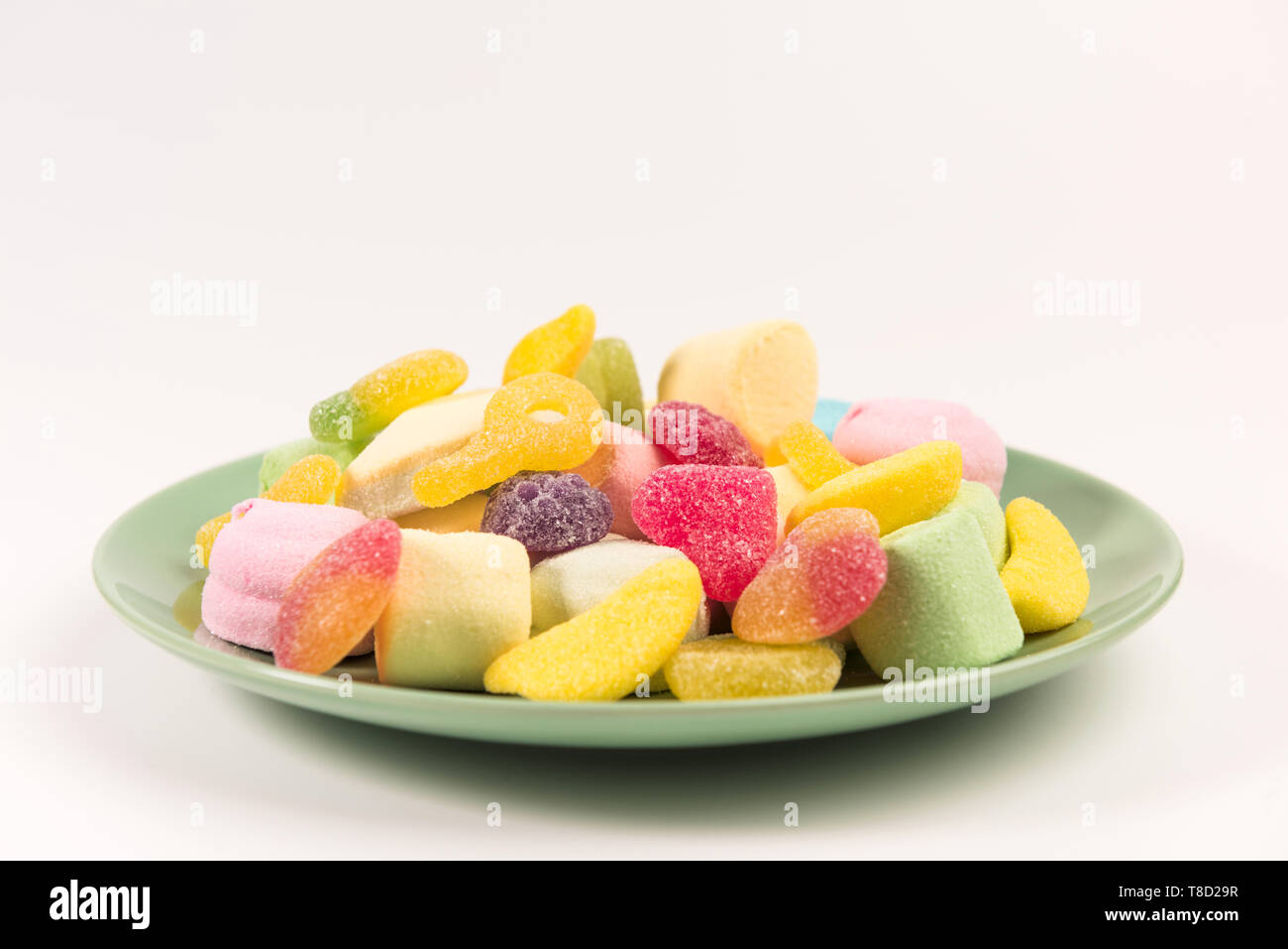 Plate with sweets isolated on a white background. Marmalade and ...