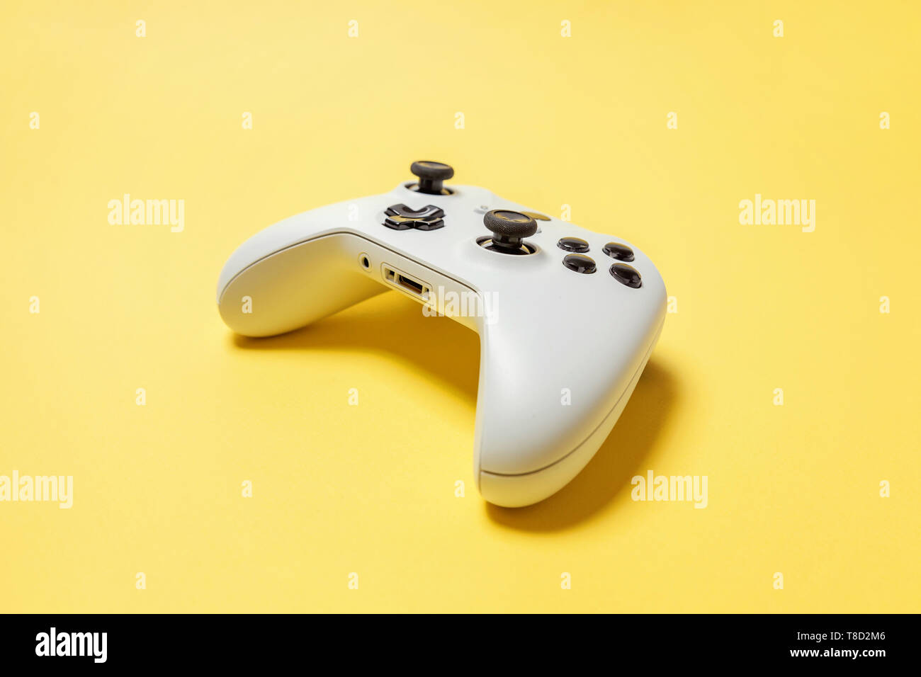 White joystick gamepad, game console on yellow colourful trendy modern ...