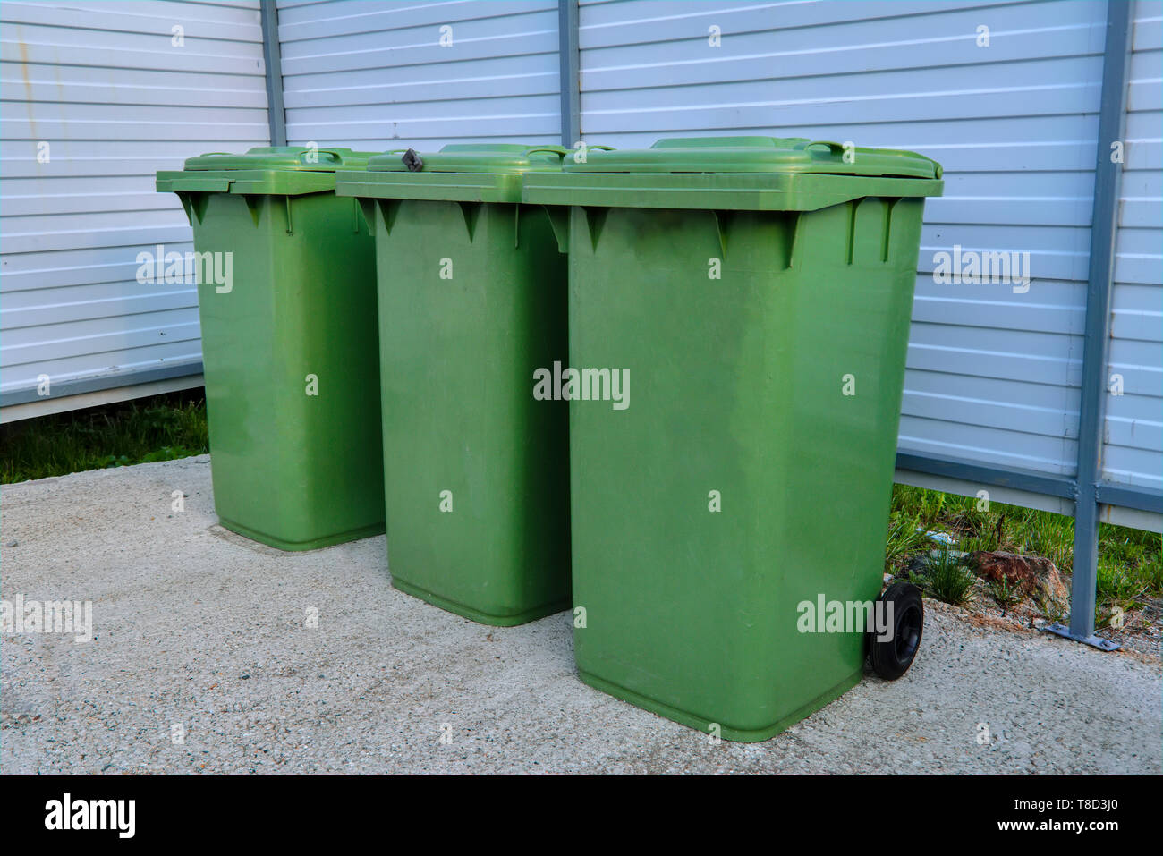 Green containers for collecting garbage on the dustbin Stock Photo - Alamy