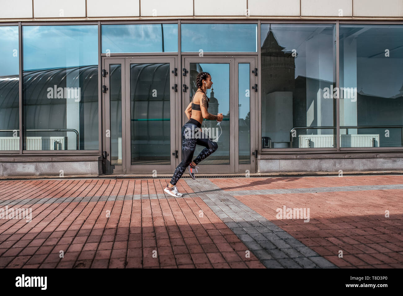 Girl morning run summer city woman background glass doors building ...